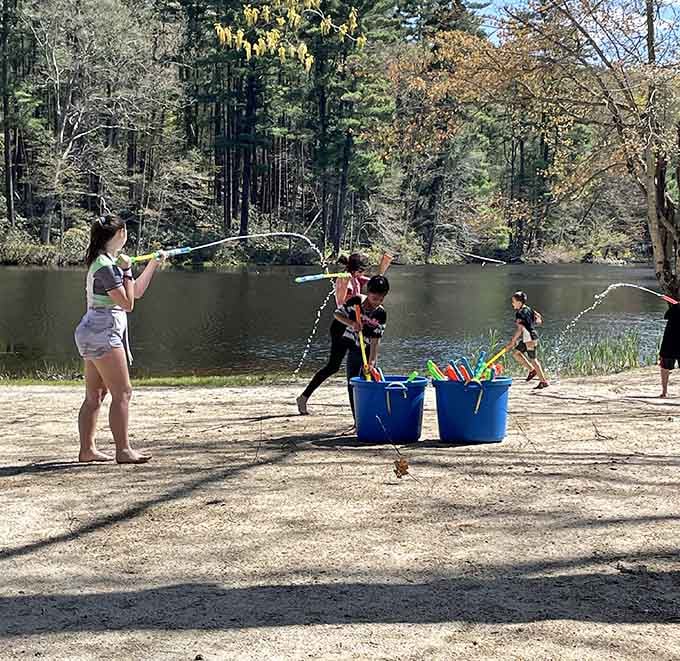 Pure lakeside joy, water guns blazing, proof that the best fun needs no Wi-Fi.