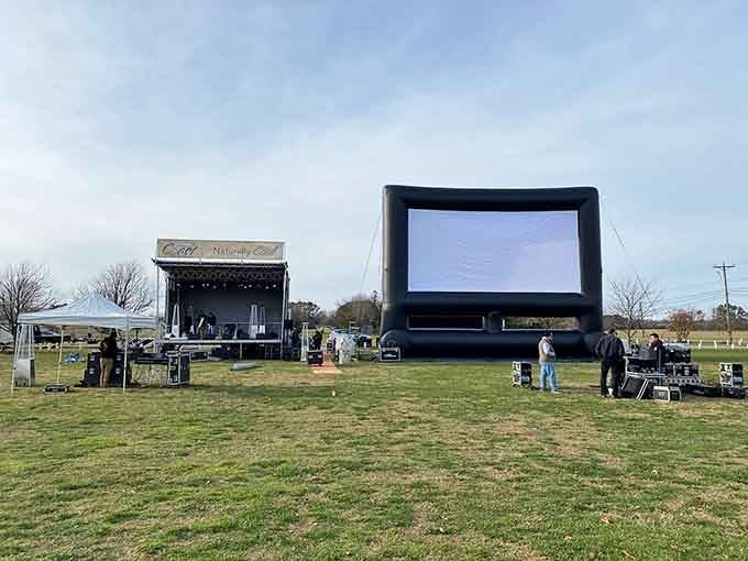 An outdoor stage and an inflatable movie screen sitting in an open field, small-town entertainment done with surprisingly big ambitions.