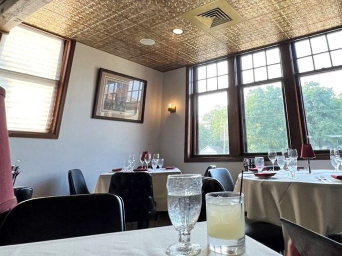 Afternoon light through those dark-framed windows turns every table into the best seat in the house.
