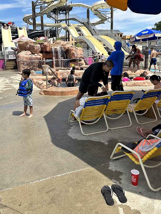 Lounge chairs, damp flip-flops, and a cold drink nearby, the universal language of a waterpark afternoon done right.