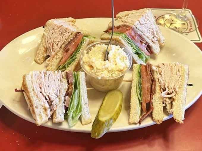 The Turkey Club arrives looking like it means business, cut into triangles, with a pickle standing at attention.
