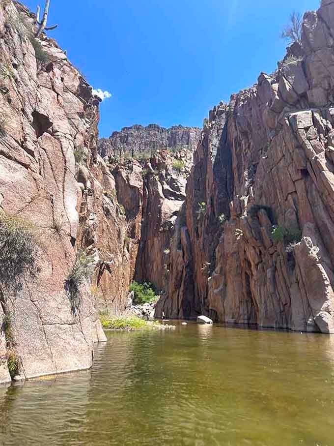 Towering canyon walls frame the water below, creating a natural cathedral that makes you whisper in awe.