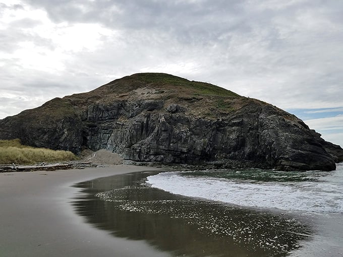 Framed by ancient rock walls, two sea stacks stand guard over a beach that feels entirely yours.