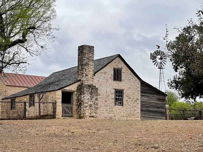 Limestone walls, a tall chimney, and a windmill standing guard, this farm was built to last forever.