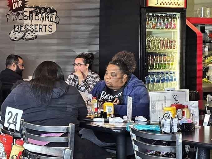 The sign on the wall says "Fresh Baked Desserts," and judging by these happy diners, nobody's skipping that part.