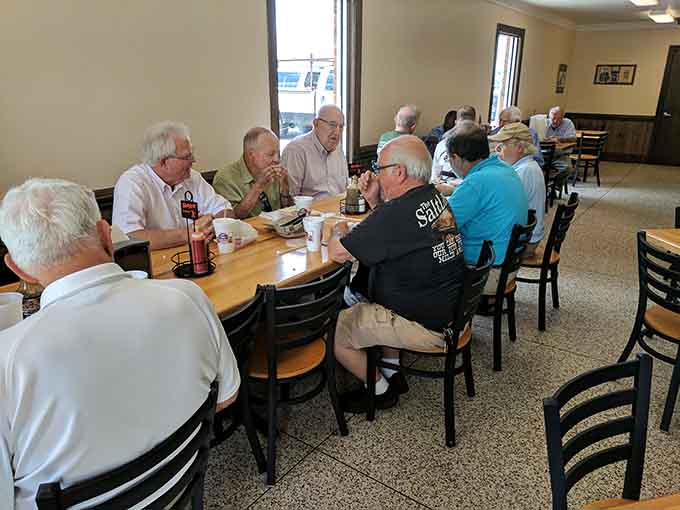 Regulars gathered around the big table &mdash; this is what a true community barbecue spot looks and feels like.