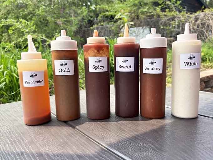 Six house-made sauces lined up like a delicious starting lineup, Pig Pickin' batting first.