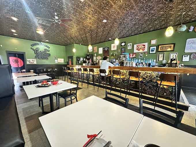 White tables, wooden chairs, and a pressed tin ceiling that makes every meal feel a little more special.