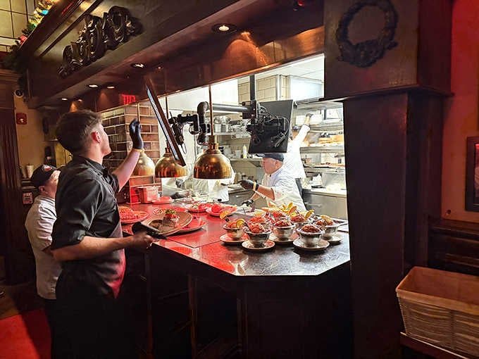 Behind that open kitchen window, the real magic happens, shrimp cocktails lined up and ready to change someone's evening.