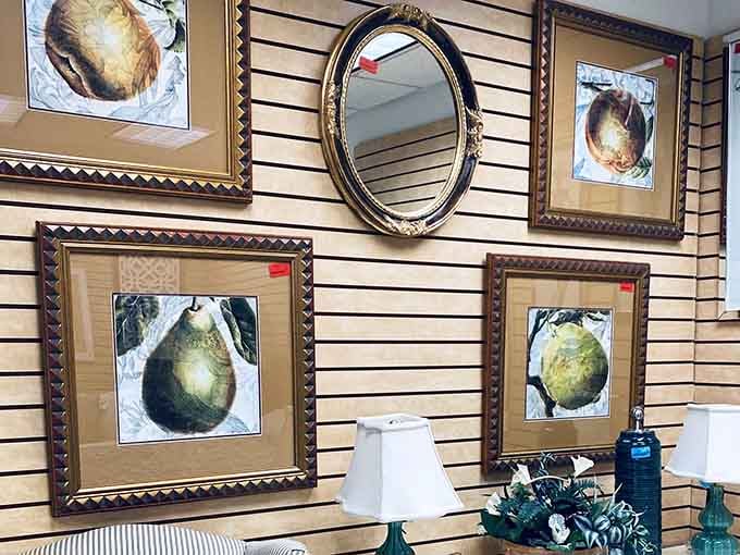 Framed fruit prints and an oval mirror create a gallery wall starter kit at bargain basement prices.