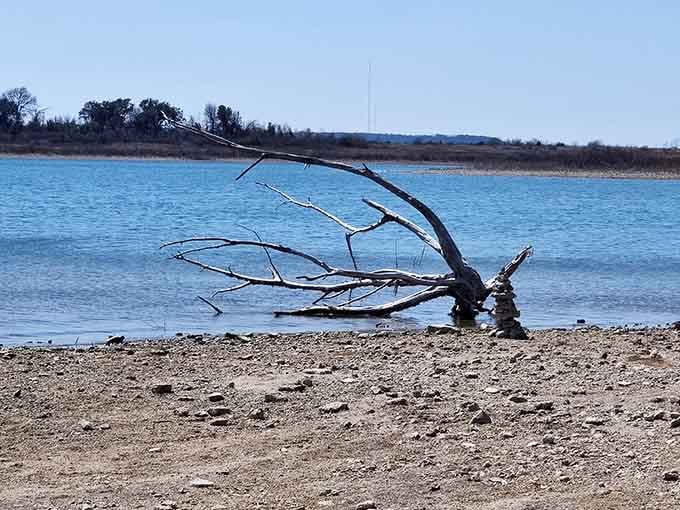 Driftwood and stacked stones tell quiet stories of visitors who fell in love with this shoreline.