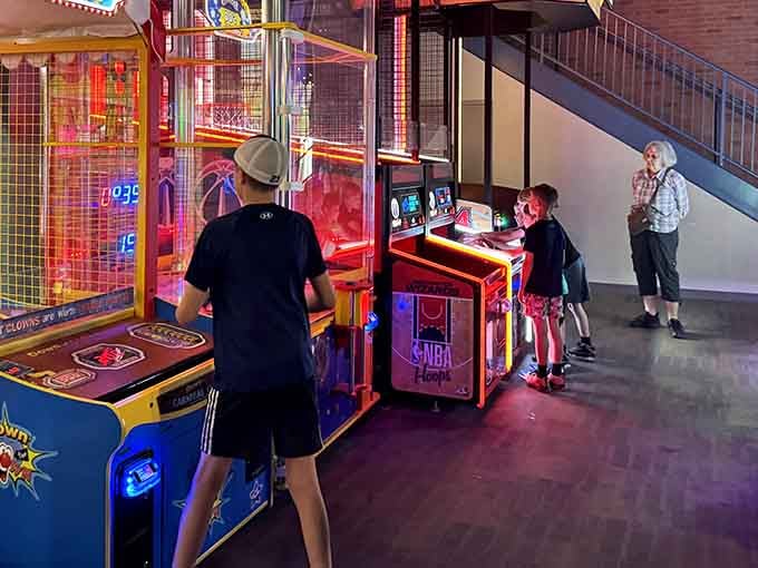 Kids locked in fierce NBA Hoops competition while grandma watches approvingly &mdash; three generations, one perfect night out.