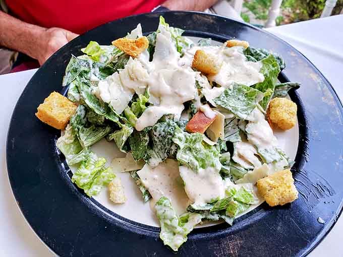 A generous Caesar salad with golden croutons and creamy dressing, simple and honest and exactly right.