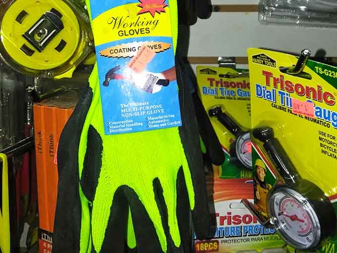 Neon yellow working gloves and a dial tire gauge side by side, because Super 99 Century has your garage covered too.