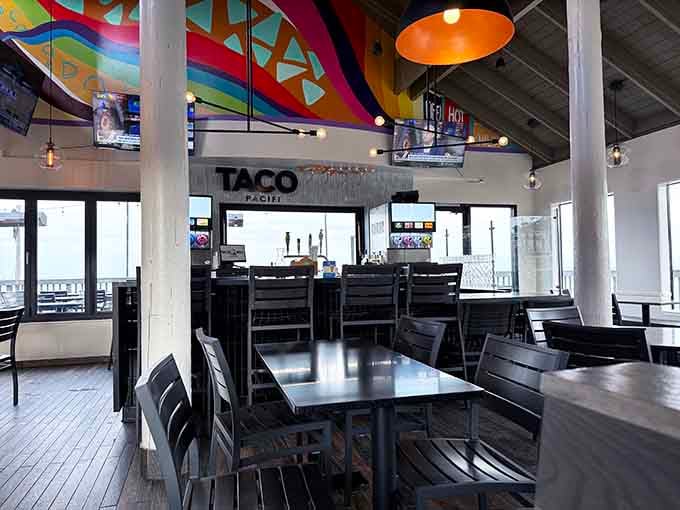 High ceilings, pendant lights, bold murals, and dark wood tables. This dining room means business, the fun kind.