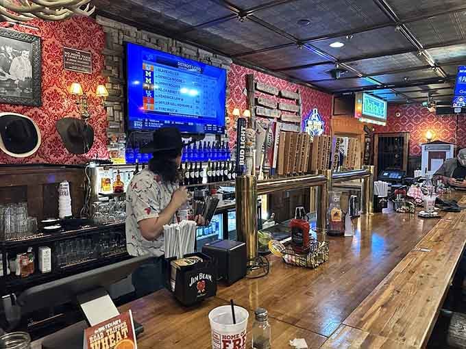 A long wooden bar, cold taps ready to pour, and a bartender who looks busy.