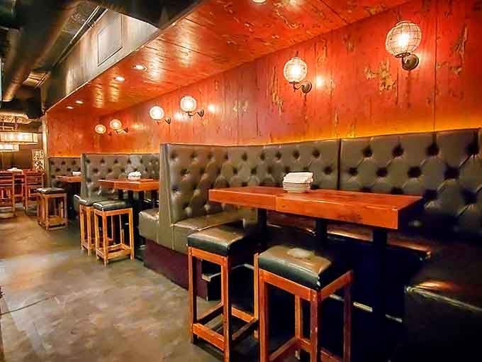 Tufted booths and warm wood create cozy corners perfect for lingering over Southern comfort food and good conversation.