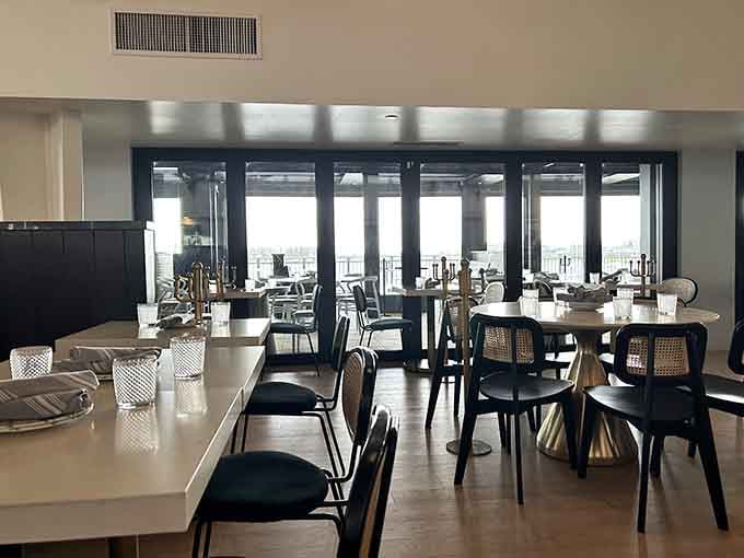 The upper dining room looks out over the water, where every table feels like the best seat in the house.