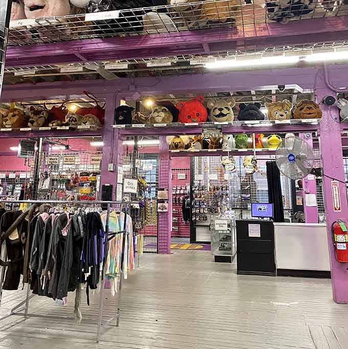 The pink walls and exposed ceiling create an industrial-chic vibe that somehow makes secondhand shopping feel like high fashion.