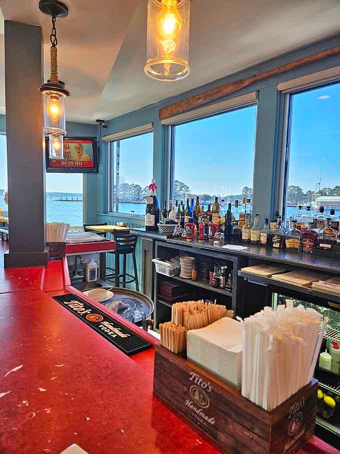 A waterfront bar with a red countertop and water views. Sitting here is basically a vacation in itself.