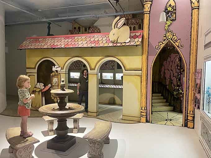 A storybook courtyard complete with arches, a fountain, and a very important rabbit keeping watch from above.