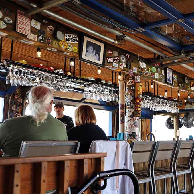 Bumper stickers, framed photos, wine glasses overhead, and a bartender who's heard every joke. This bar has genuine character.