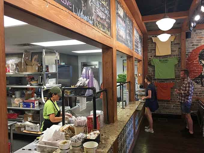 The open kitchen and friendly counter service create an atmosphere where watching your food being made is half the fun.