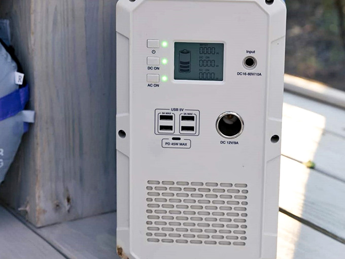 A portable power supply tucked neatly on the deck. Even off the grid, your phone survives. You're welcome.