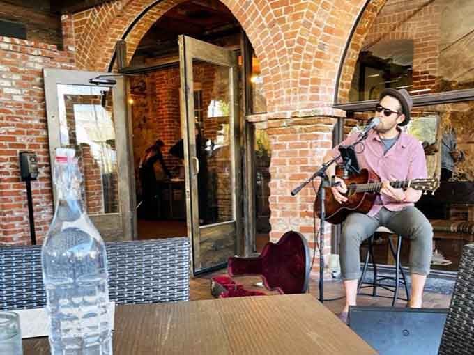 Live acoustic guitar echoing off century-old brick walls. Trevor's figured out that great food sounds even better with a soundtrack.