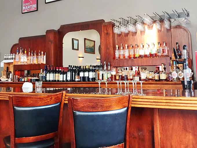 A well-stocked bar with warm wood tones invites you to settle in for a proper drink before dinner.