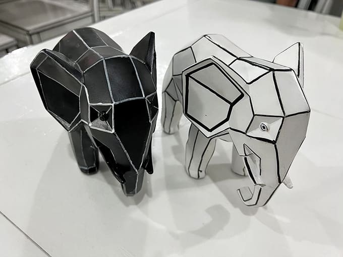 Geometric elephant sculptures continue the monochrome theme, adding playful touches throughout the dining room experience.