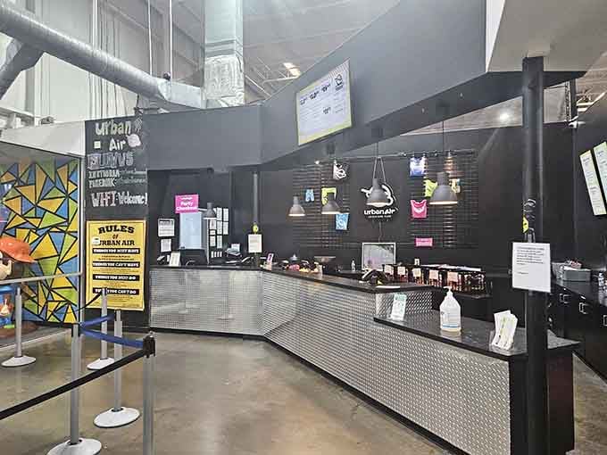 The sleek service desk is where dreams begin and waivers get signed, because lawyers ruin everything fun.