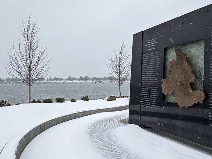 Snow on the waterfront changes everything. The Columbia River memorial panels look quietly powerful against a winter backdrop.