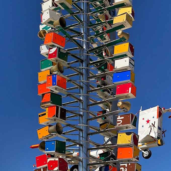 Stacked with colorful panels and bells, this tower catches both wind and light with remarkable, almost musical precision.
