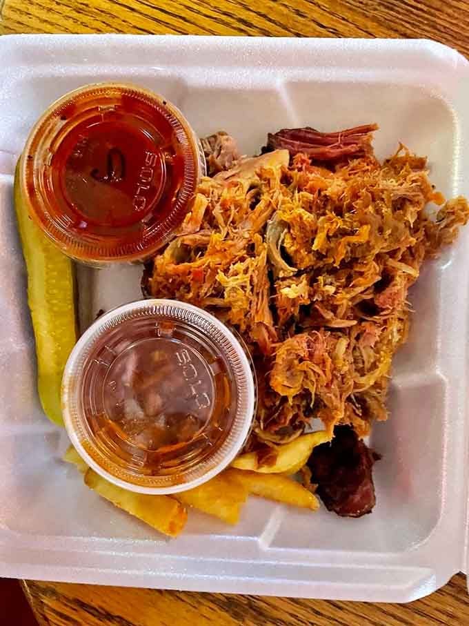 Pulled pork so tender and smoky, two little cups of sauce on the side feel like a very generous bonus.