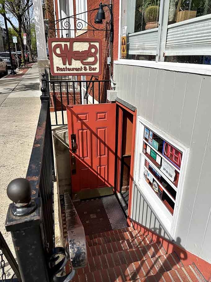 That red door at the bottom of the steps is your invitation, and trust us, you absolutely want to accept it.