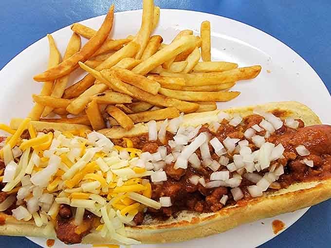 A foot-long coney dog loaded with chili, shredded cheese, and diced onions. Michigan on a plate, no debate needed.