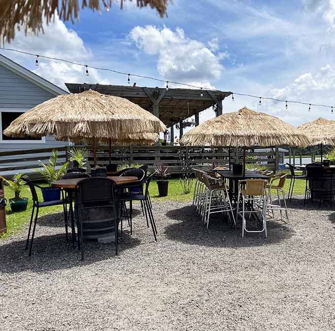 String lights, thatched umbrellas, and open skies overhead. The outdoor seating here turns every meal into a small celebration.