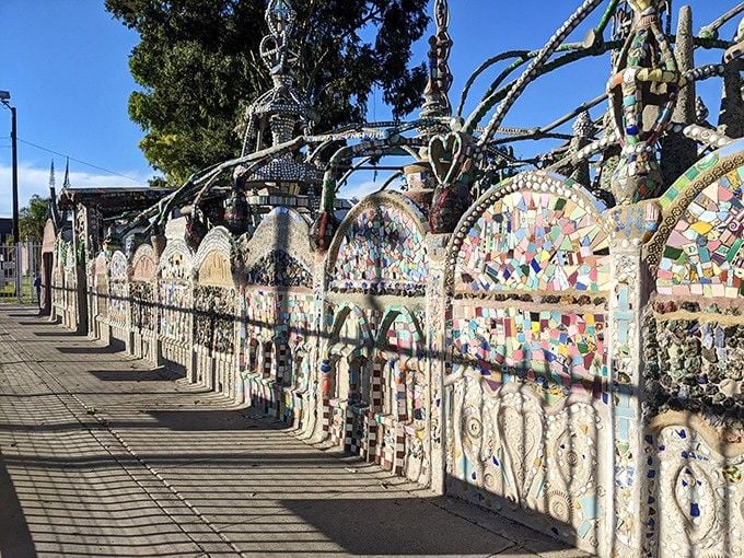 This long mosaic wall stretches along the sidewalk like a colorful sentence that just keeps going, and you never want it to end.