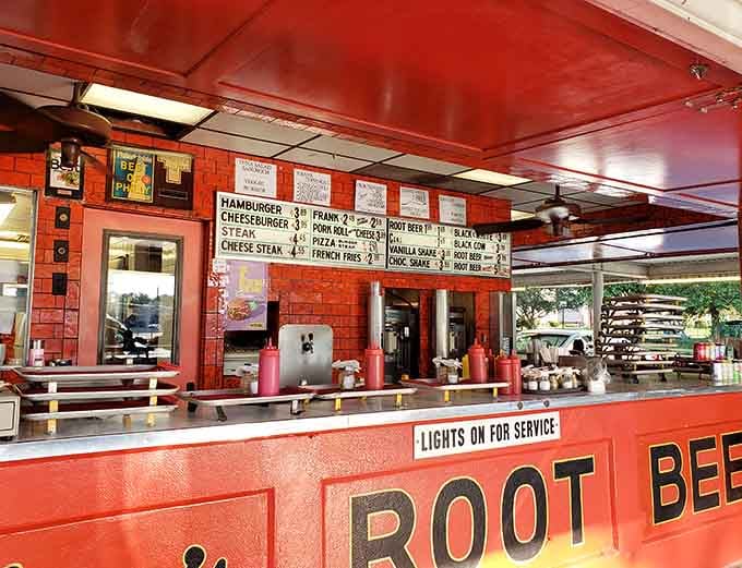 That vivid red counter with "Lights On For Service" painted right on it is drive-in culture at its most charming.