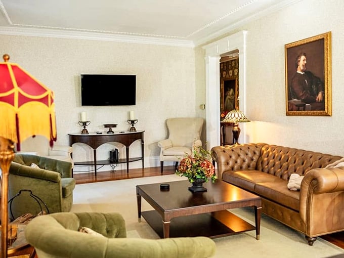 Tufted leather sofa, oil portrait, Tiffany lamp. This living room is what "refined comfort" actually looks like.