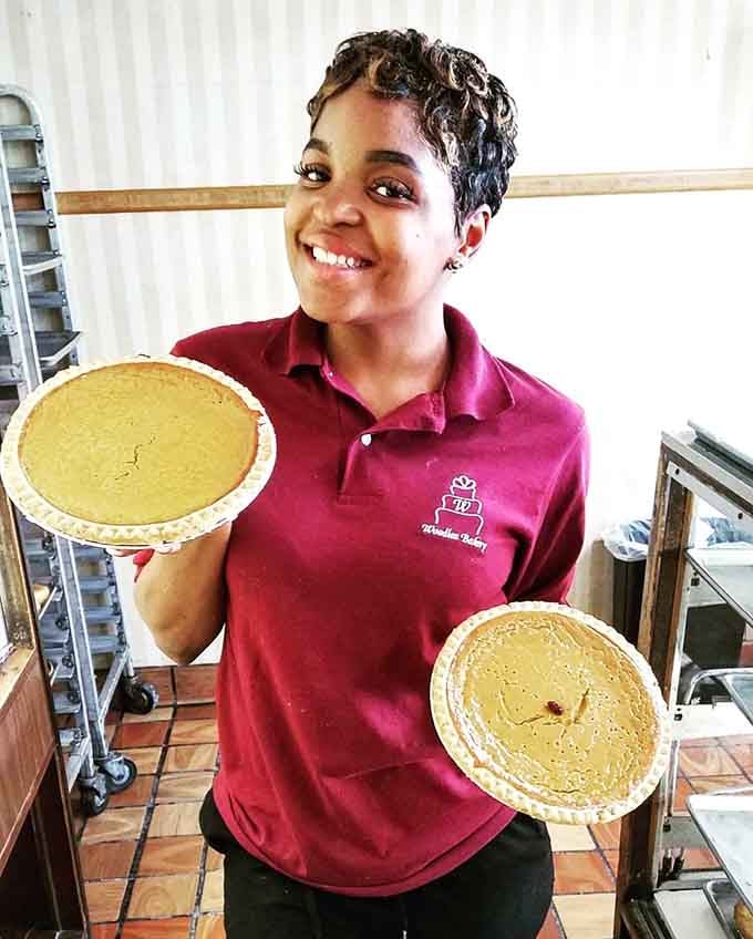 Holding two beautiful pies like trophies, because at Woodlea Bakery, every pie absolutely deserves that kind of celebration.