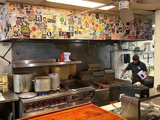 Stickers covering every inch above the line, that kitchen hood is basically a scrapbook of everyone who ever loved this place.