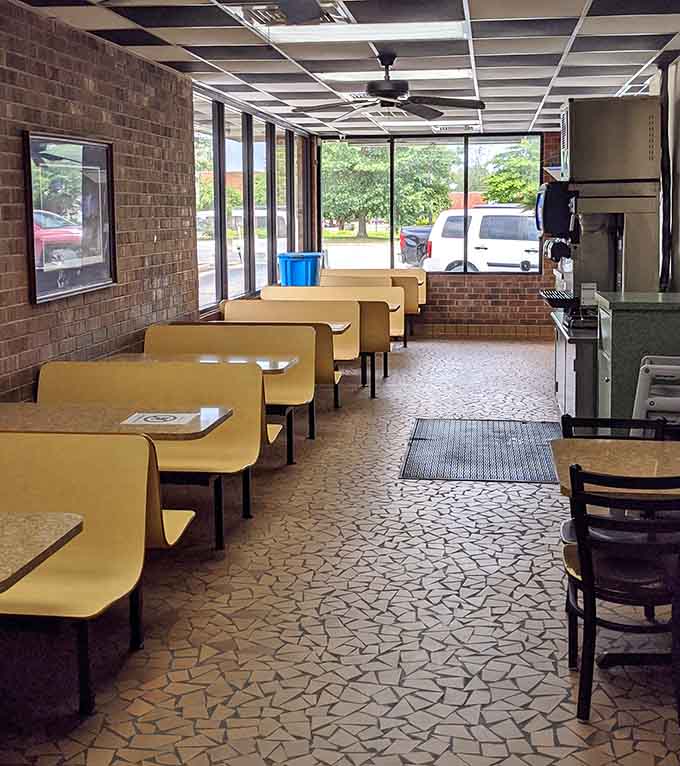 Yellow booths, big windows, and afternoon light streaming in. This dining room has a warmth that no interior designer could fake.
