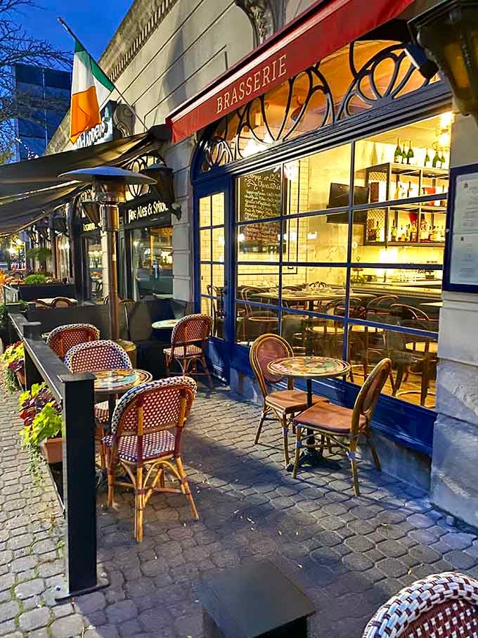 Evening lights glow through those windows while woven bistro chairs wait patiently for the next lucky diner to arrive.