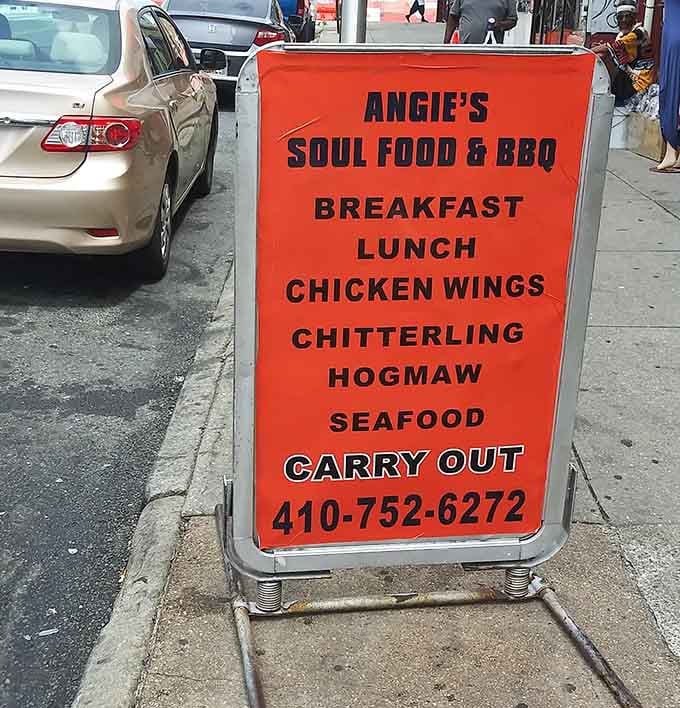A sidewalk sign that lists breakfast, lunch, chitterlings, and seafood. Honest, direct, and exactly the kind of menu that delivers.