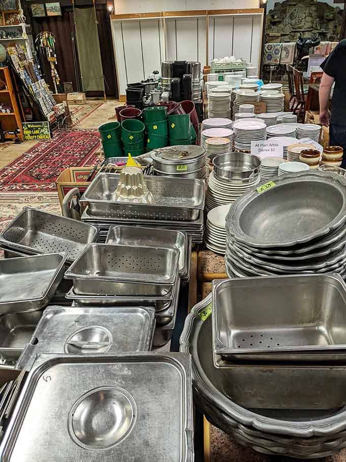 Stacks of dishes, trays, and commercial cookware piled high, practical, plentiful, and priced for people who actually cook things.
