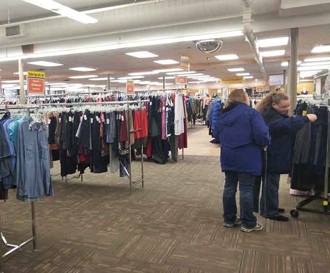 Happy shoppers working the racks like pros, because finding something great here is absolutely worth the effort.