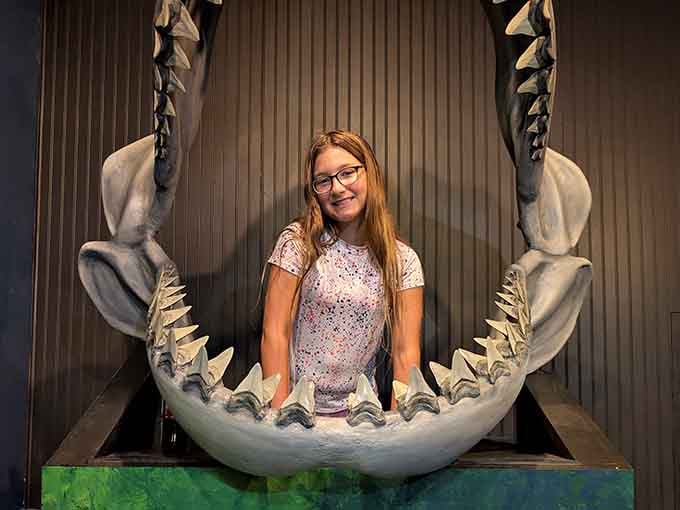 Standing inside a megalodon jaw replica, where the photo opportunity is absolutely worth every second of the drive here.