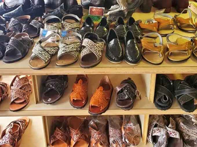Handcrafted leather sandals and huaraches lined up neatly, bringing serious artisan footwear energy to Kentucky.